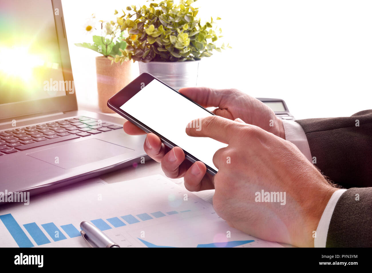 Businessman interacting and consulting a mobile in an office ...