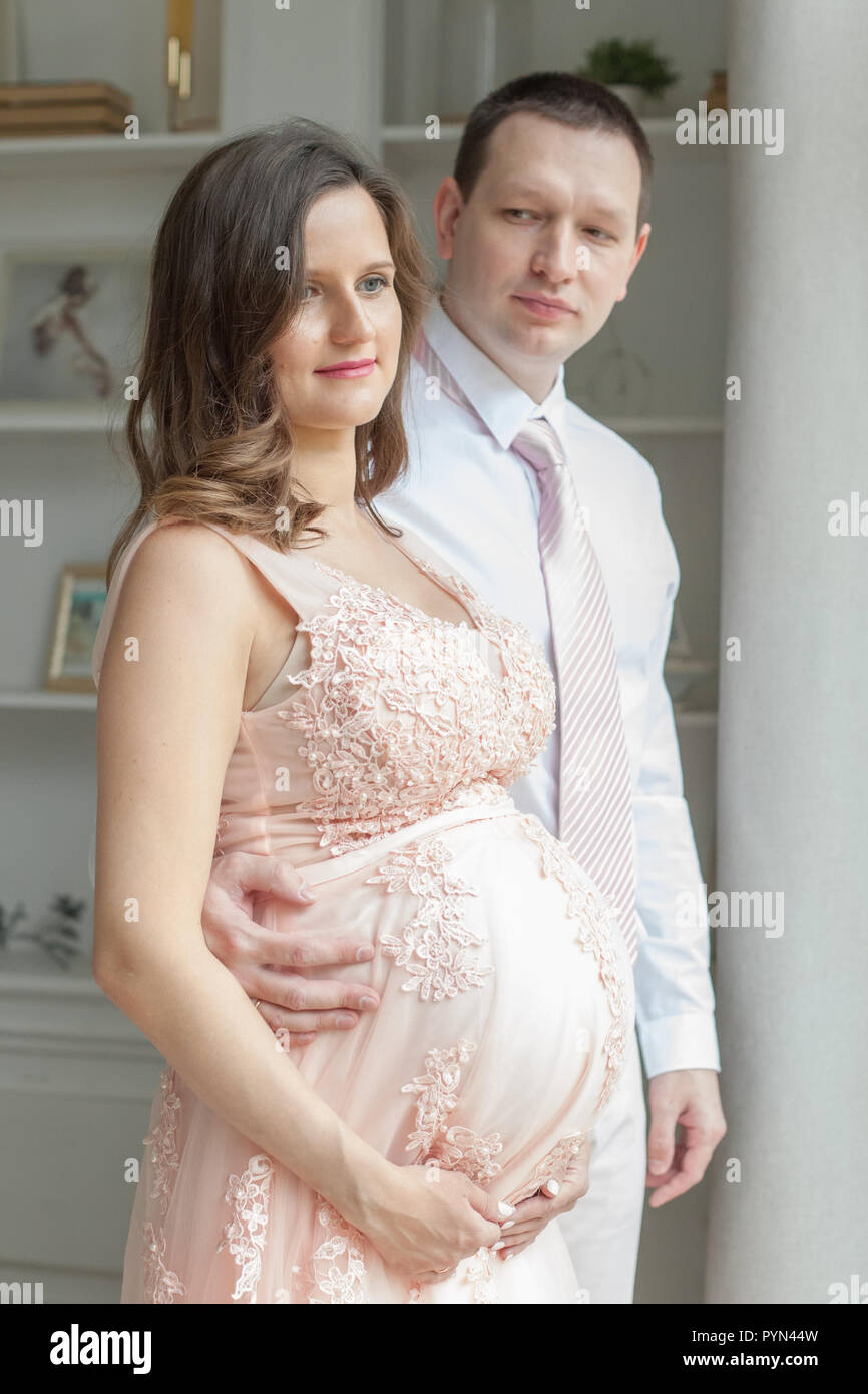 Portrait of lovely future parents at home. Pregnancy, maternity ...