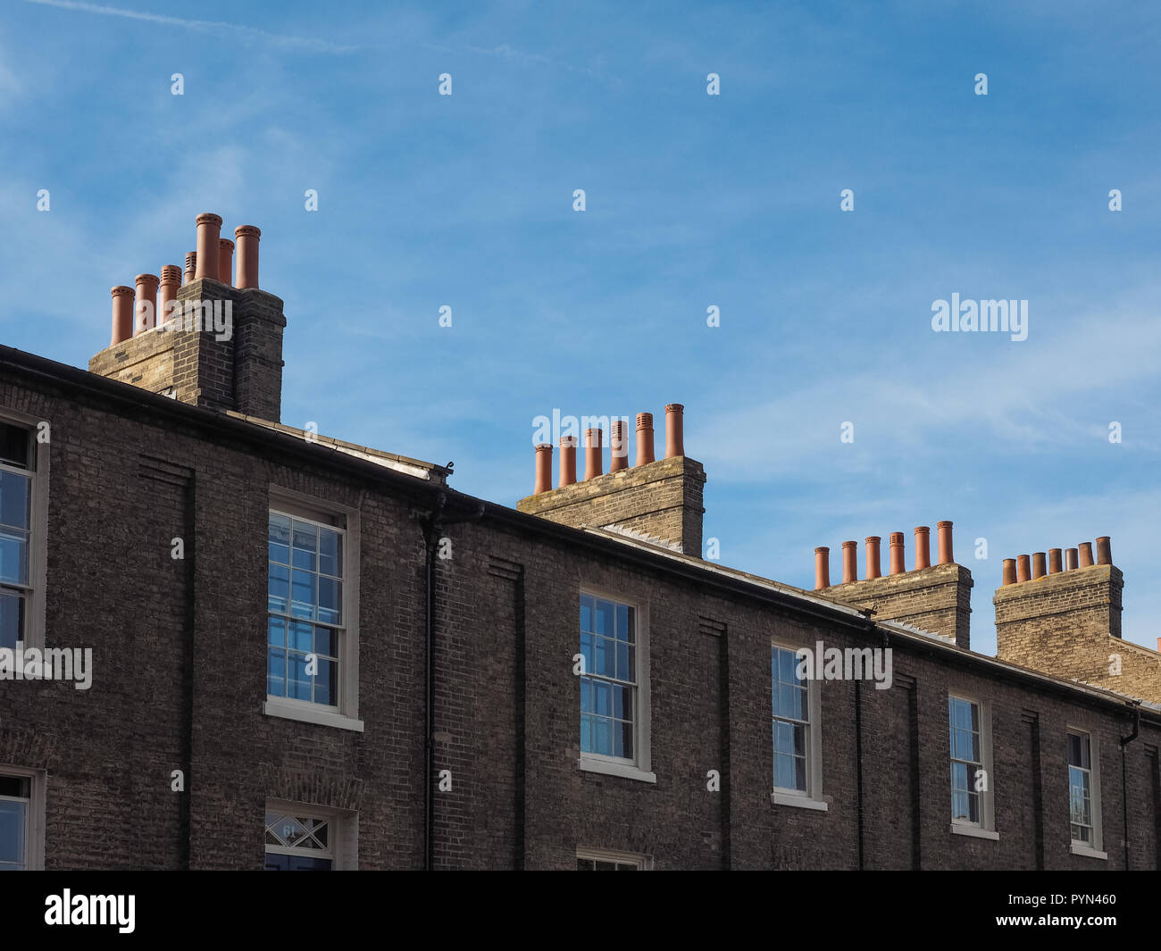 Row of traditional British houses, blue sky, red bricks Stock Photo - Alamy