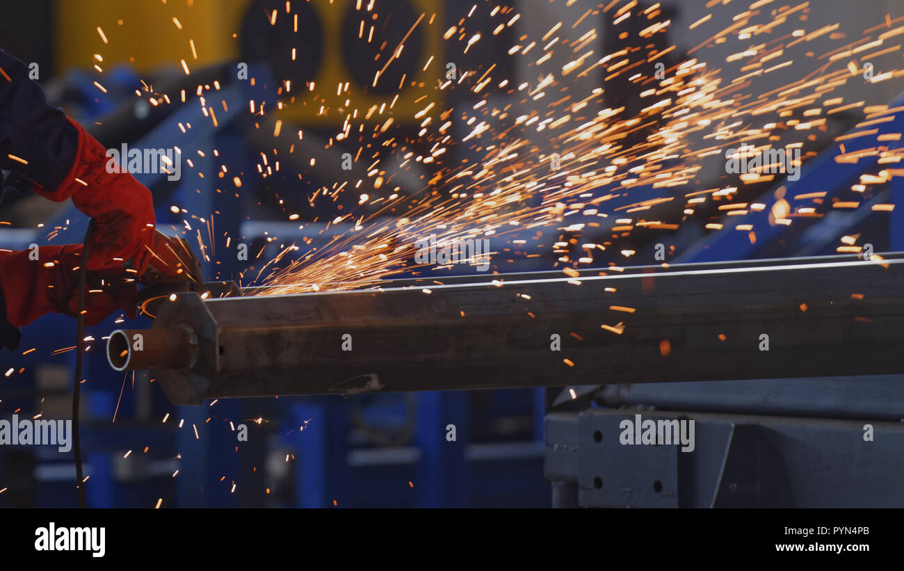 Worker grinding the steel column with hand-held grinding machine Stock ...