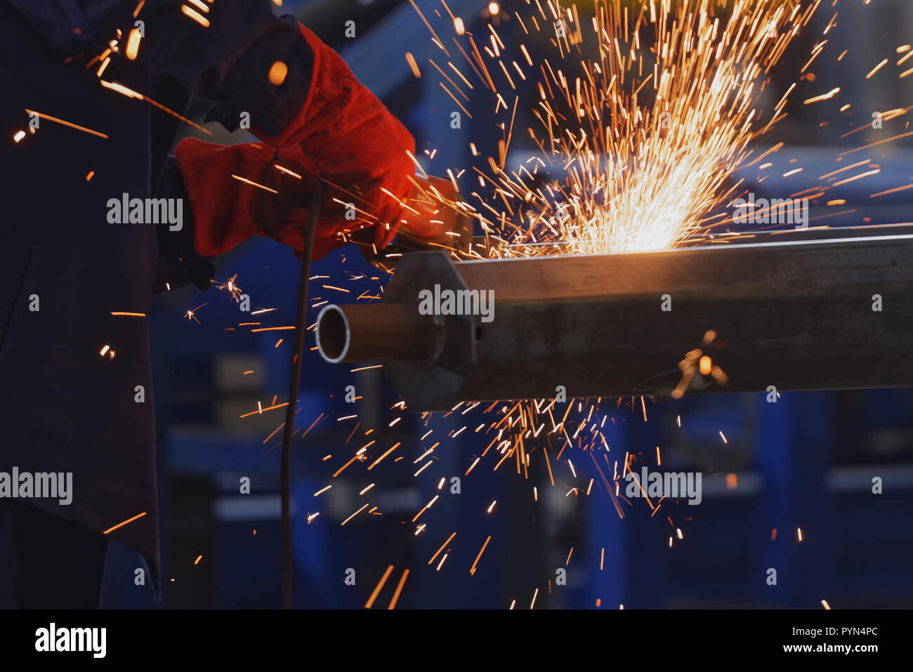 Worker grinding the steel column with hand-held grinding machine Stock ...