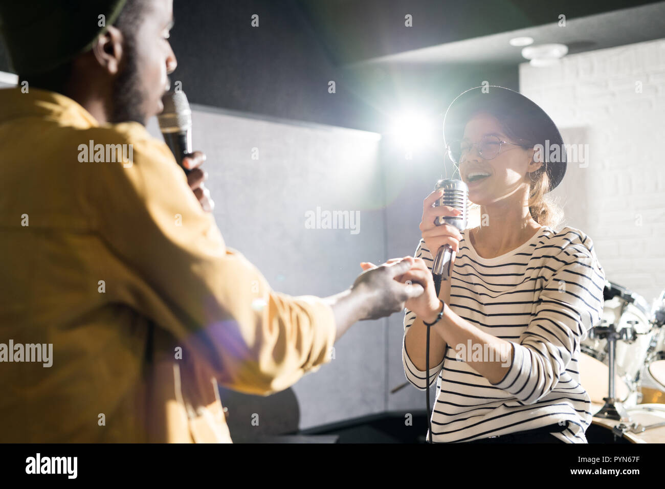 Holding mic with both hands hi-res stock photography and images - Alamy
