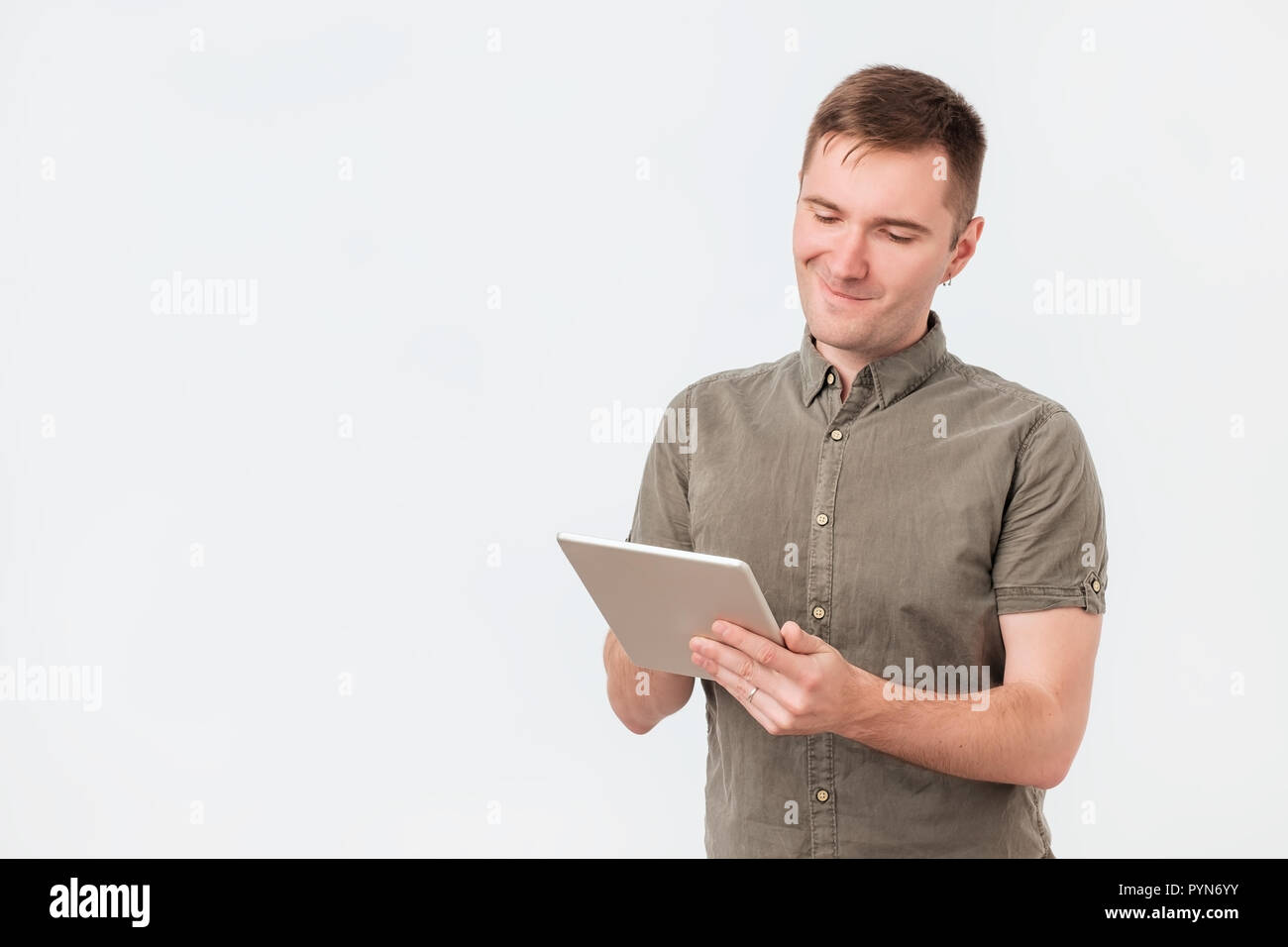 Handsome man using tablet on white background Stock Photo - Alamy