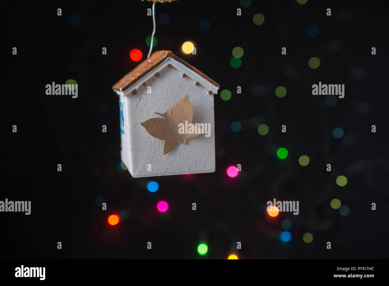 Paper butterfly on a Model house on a bokeh light Stock Photo - Alamy