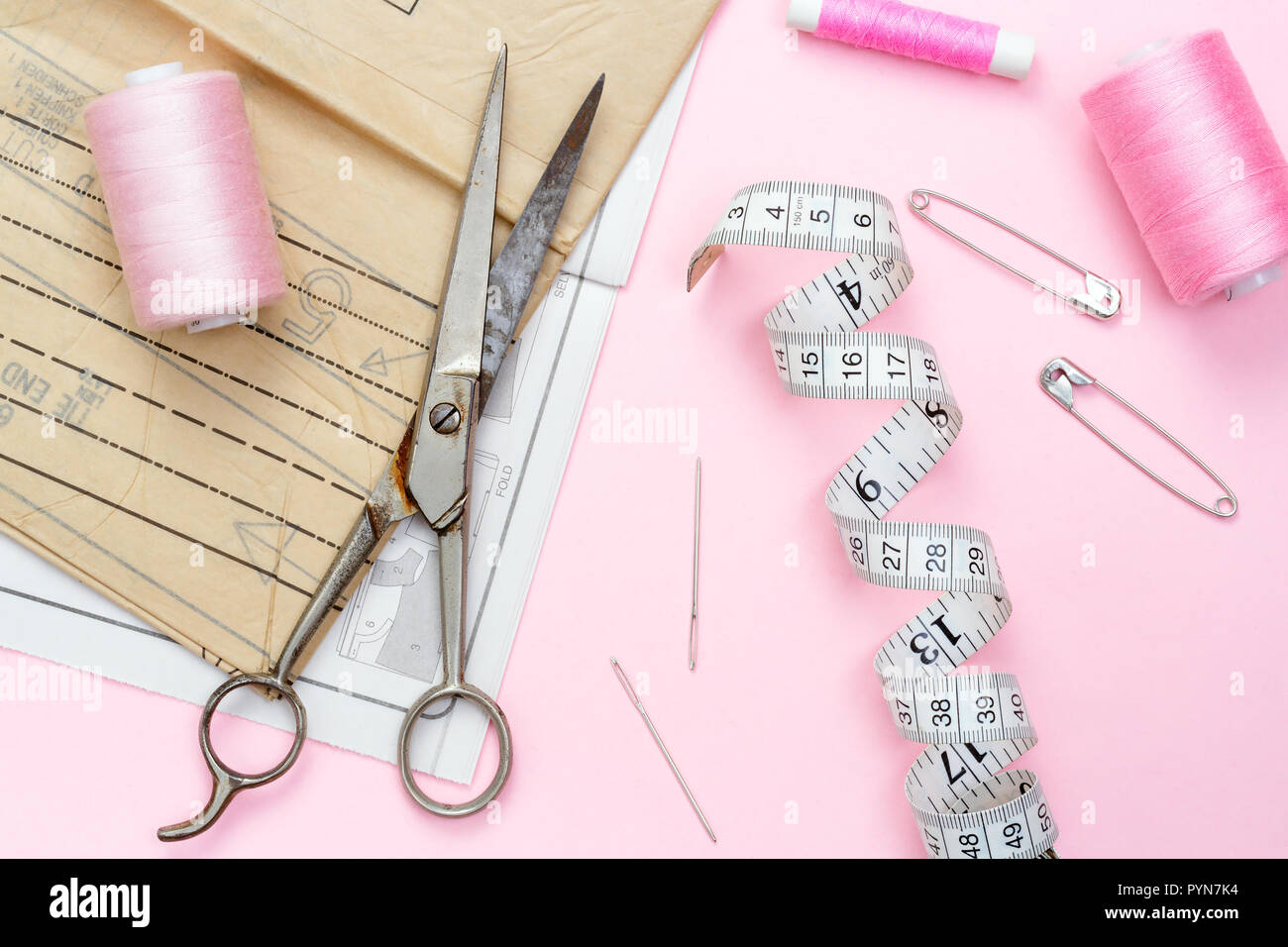 Shades of pink. Sewing pattern with scissors and tape measure used in ...