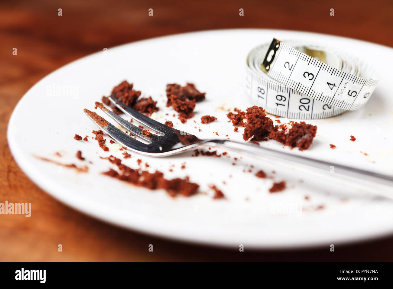 Eating chocolate cake while dieting Stock Photo - Alamy