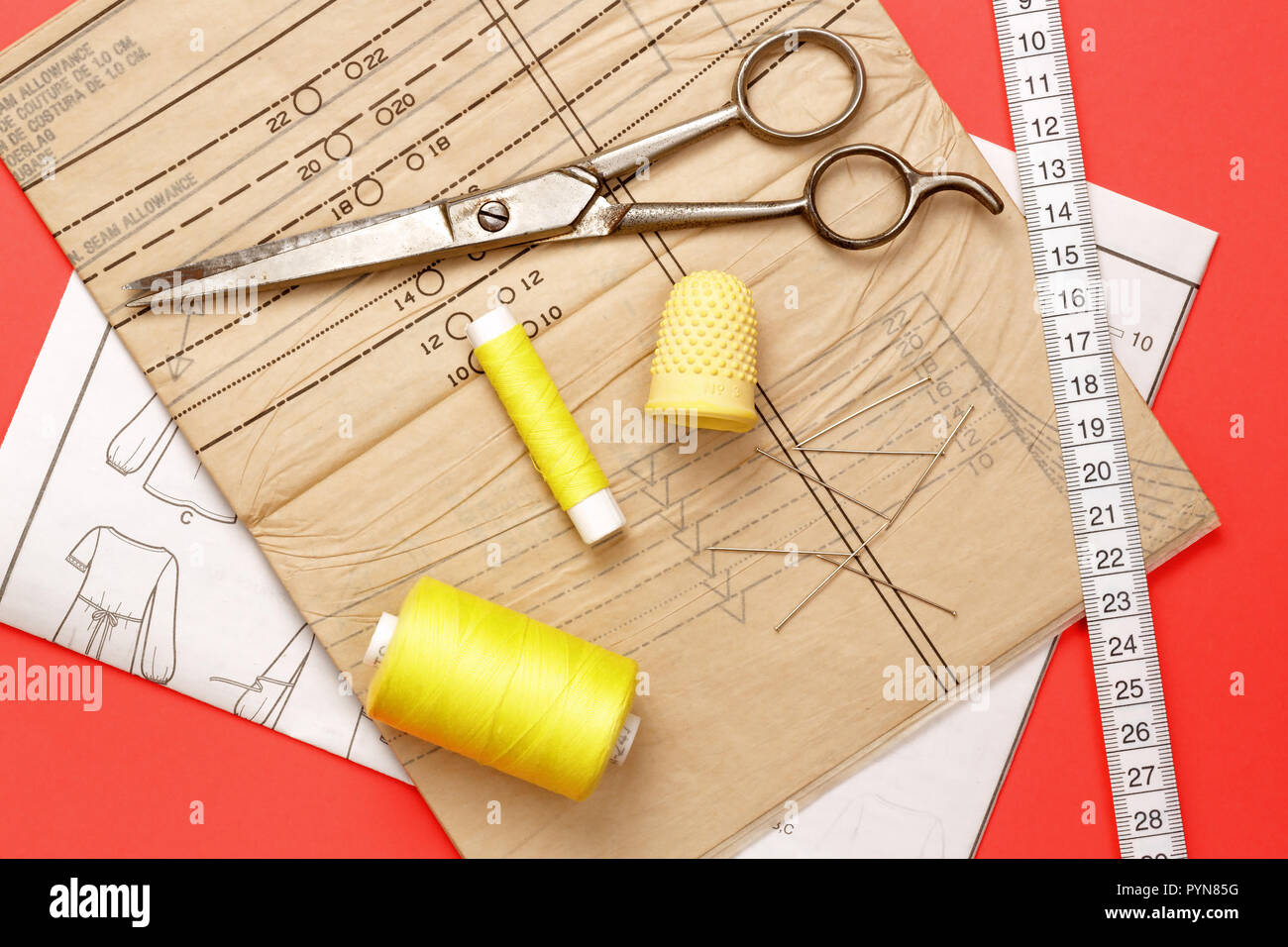 tape measure, pattern, and yellow string for sewing on fabric Stock ...