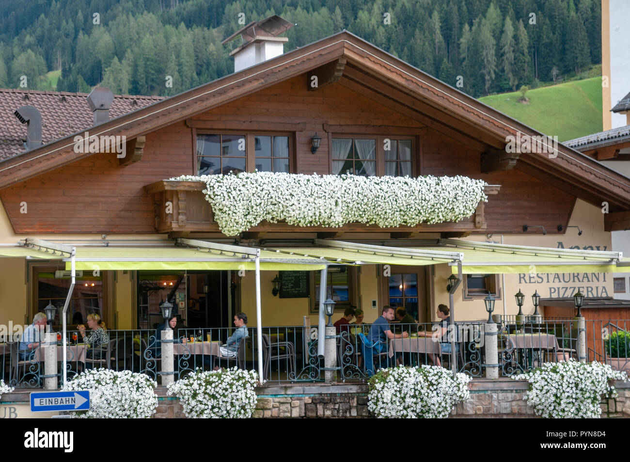 White flowers in window boxes in the facade of a typical Tirolian house ...