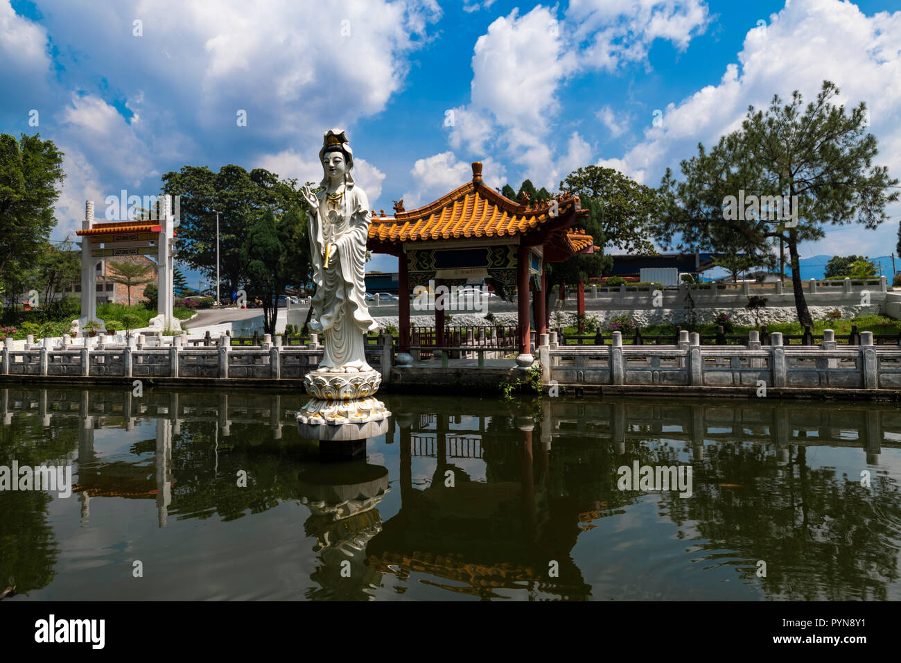Statue of Guan Yin at Perak Cave Temple standing in the middle of the ...