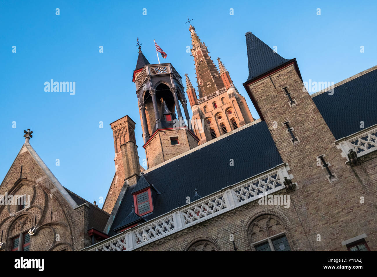 Church of Our Lady Bruges, with tower bathed in early morning light, a ...