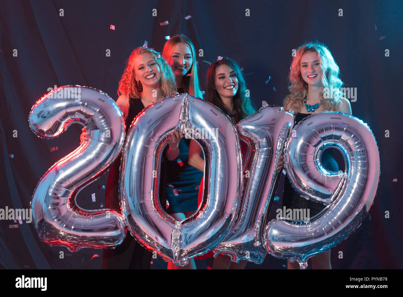 Party, people and new year holidays concept - cheerful young women ...