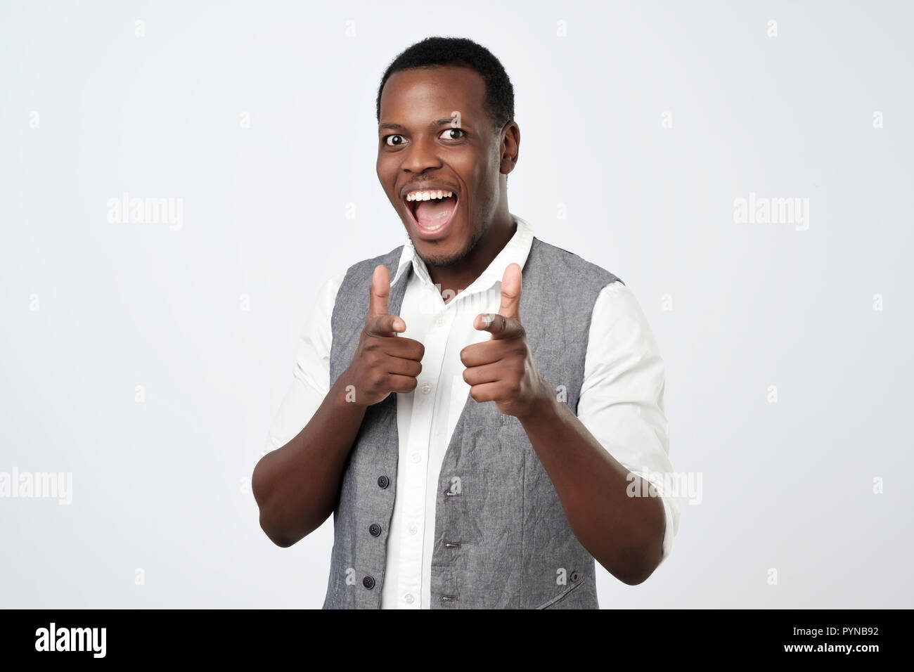Young handsome african man with two hands guns sign gesture pointing at ...