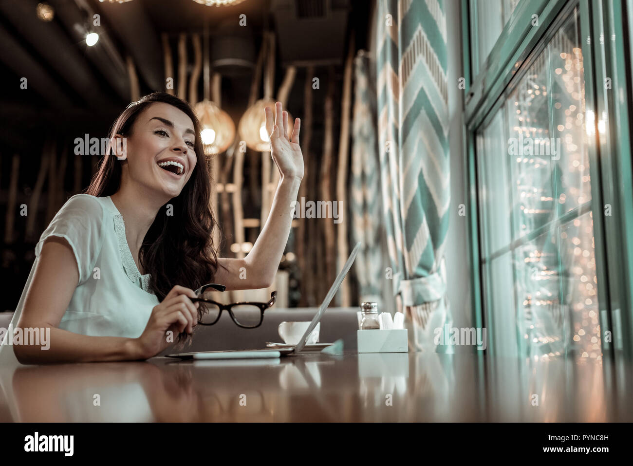 Positive delighted freelance worker waiting for her partner Stock Photo ...