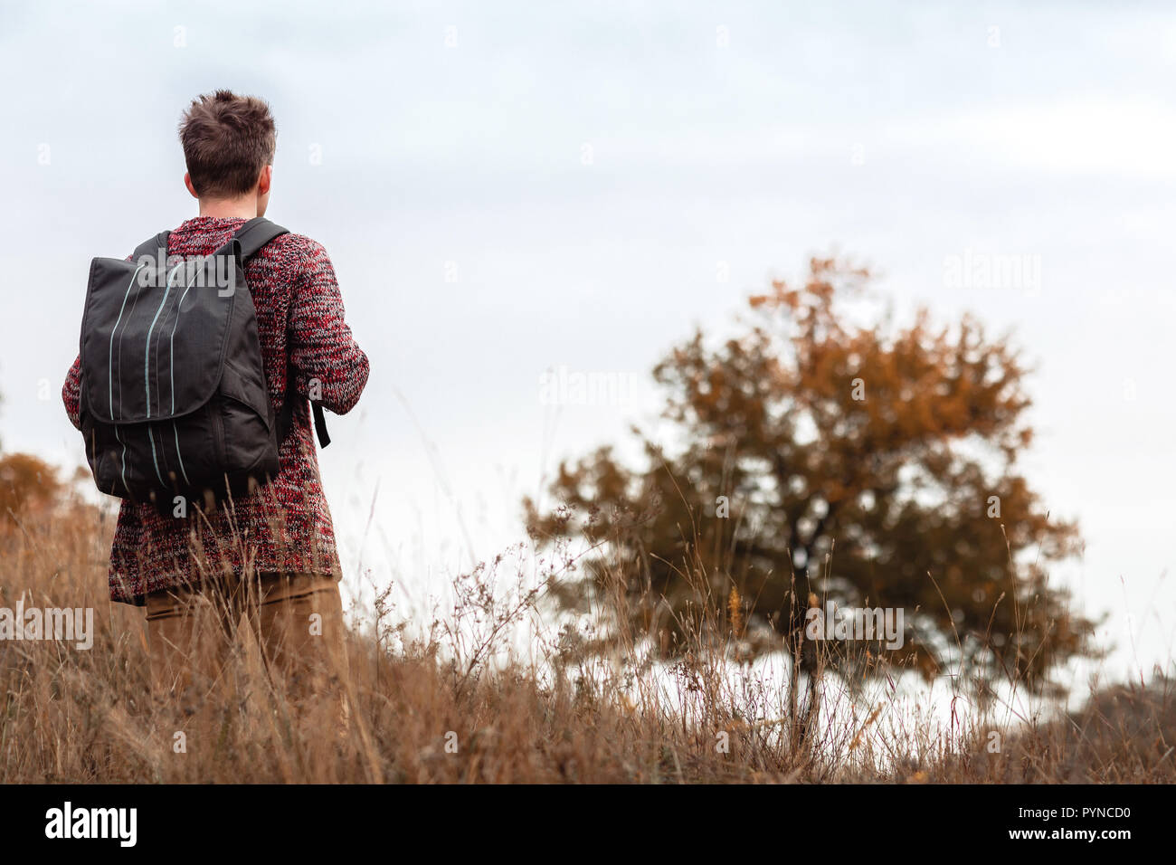 young man tourist with backpack walking on nature Stock Photo - Alamy