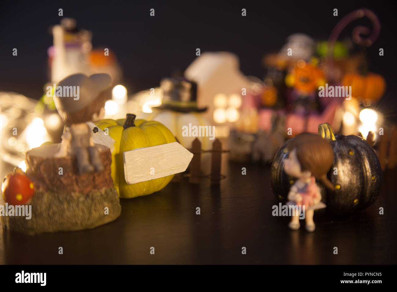 boy and girl at yellow golden pumpkin gate with blank white arrow sign ...