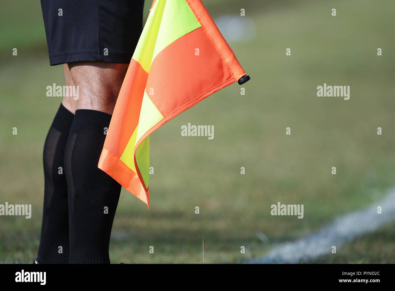 Assistant referee hold flag Stock Photo - Alamy