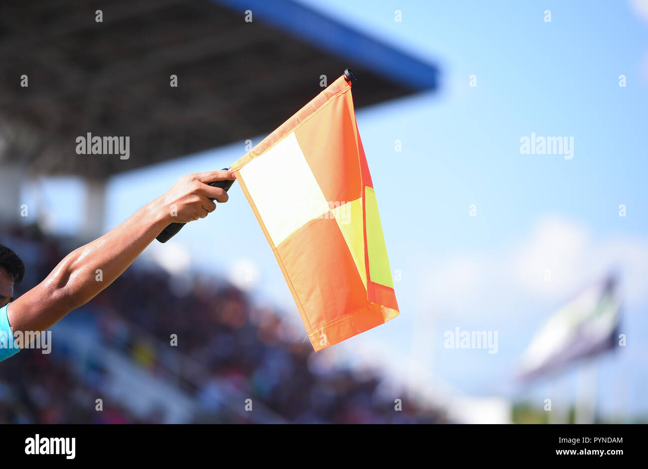 Assistant referee hold flag , offside signal Stock Photo - Alamy