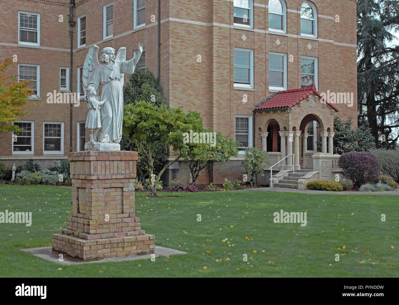 A statue of a guardian angel graces the front lawn of the Mount Angel ...