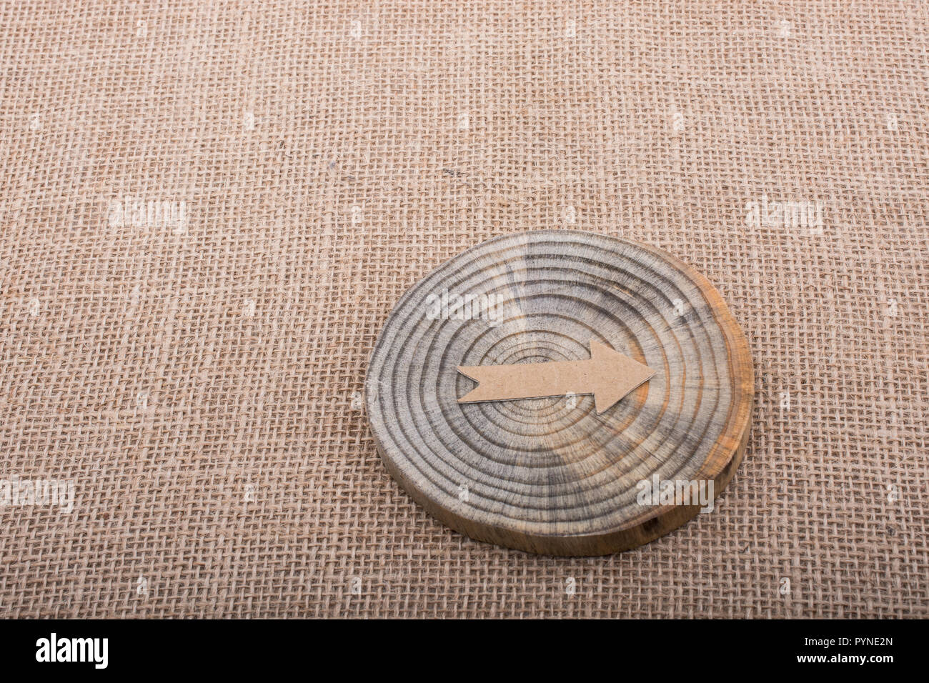 Arrow sign cut out of brown paper in view Stock Photo - Alamy