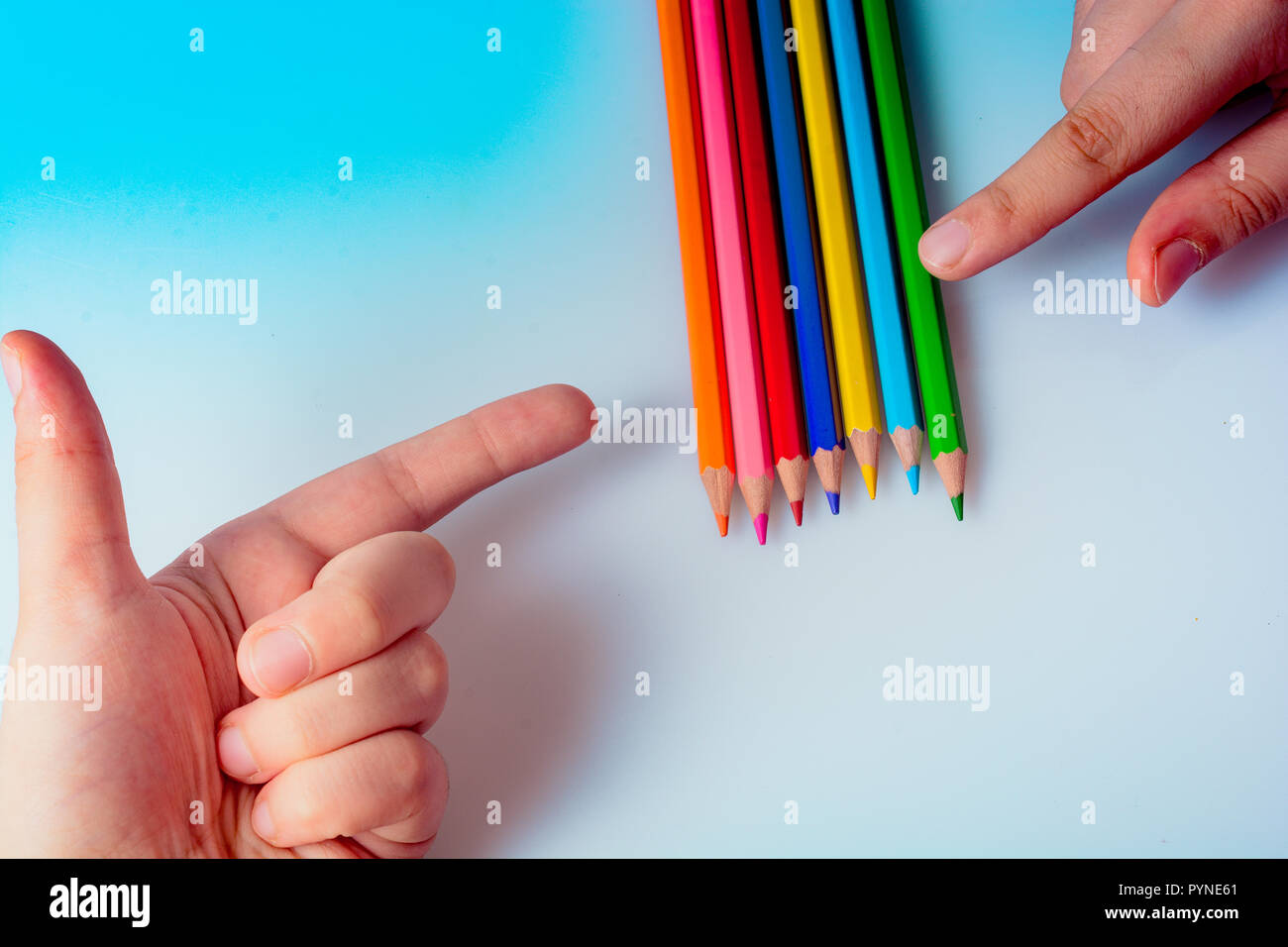 Hand holding color Pencils placed on a white background Stock Photo - Alamy