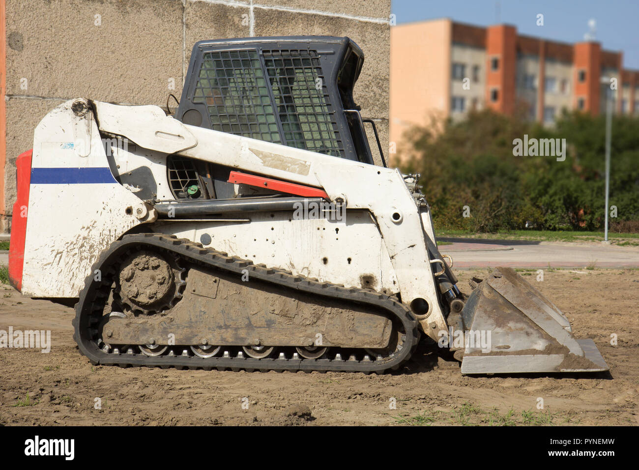 A Mini excavator bobcat standing at construction site Stock Photo - Alamy