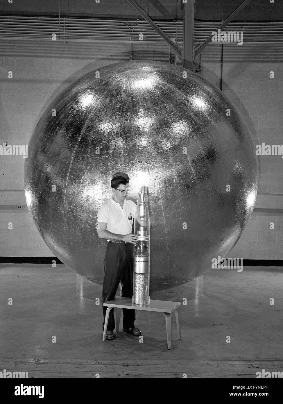 Engineer and 12 foot Beacon showing NACA emblem on inflated satelloon ...