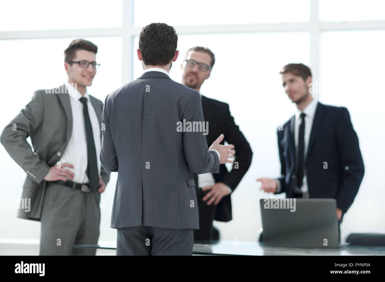 boss talking to employees standing in the office Stock Photo - Alamy