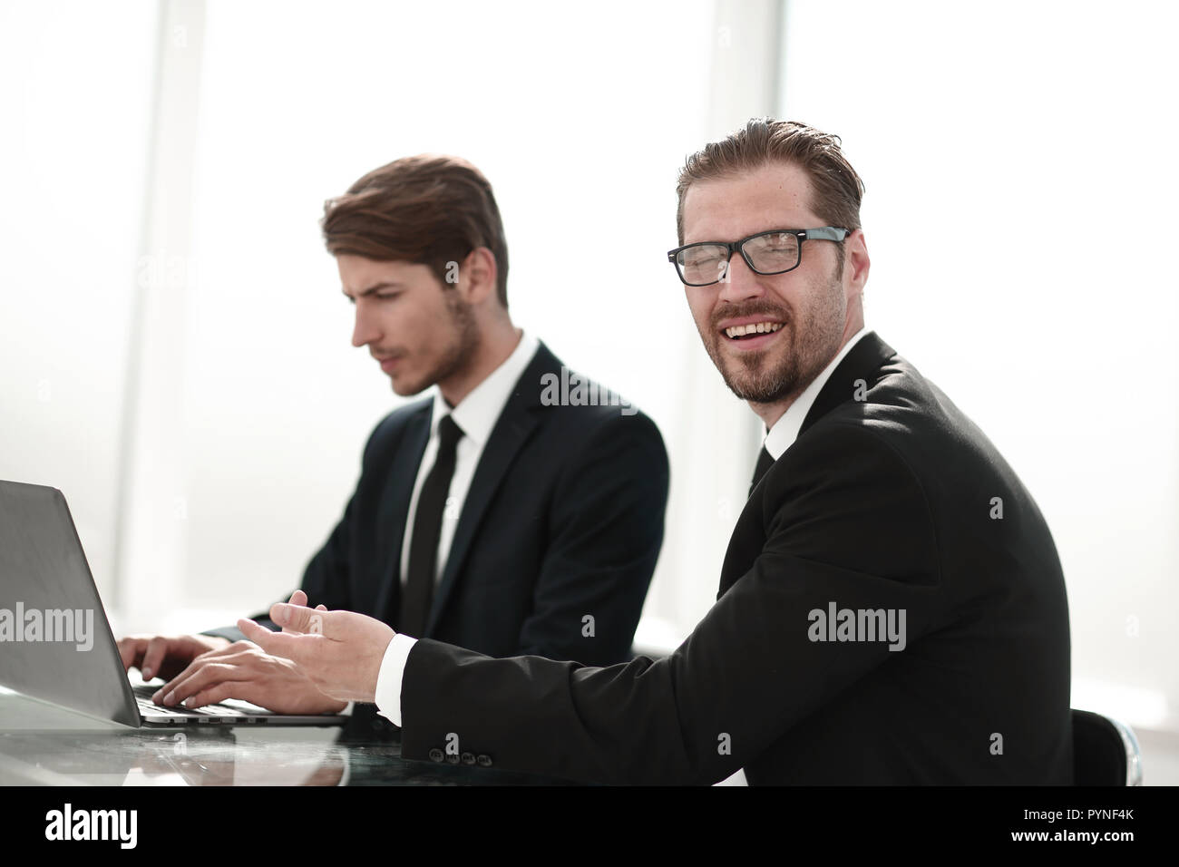 two business people sitting at the Desk Stock Photo - Alamy