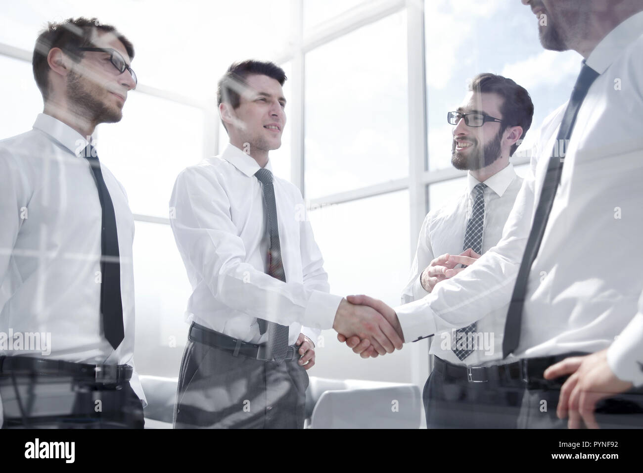 successful employees shaking hands at the workplace in the offic Stock ...
