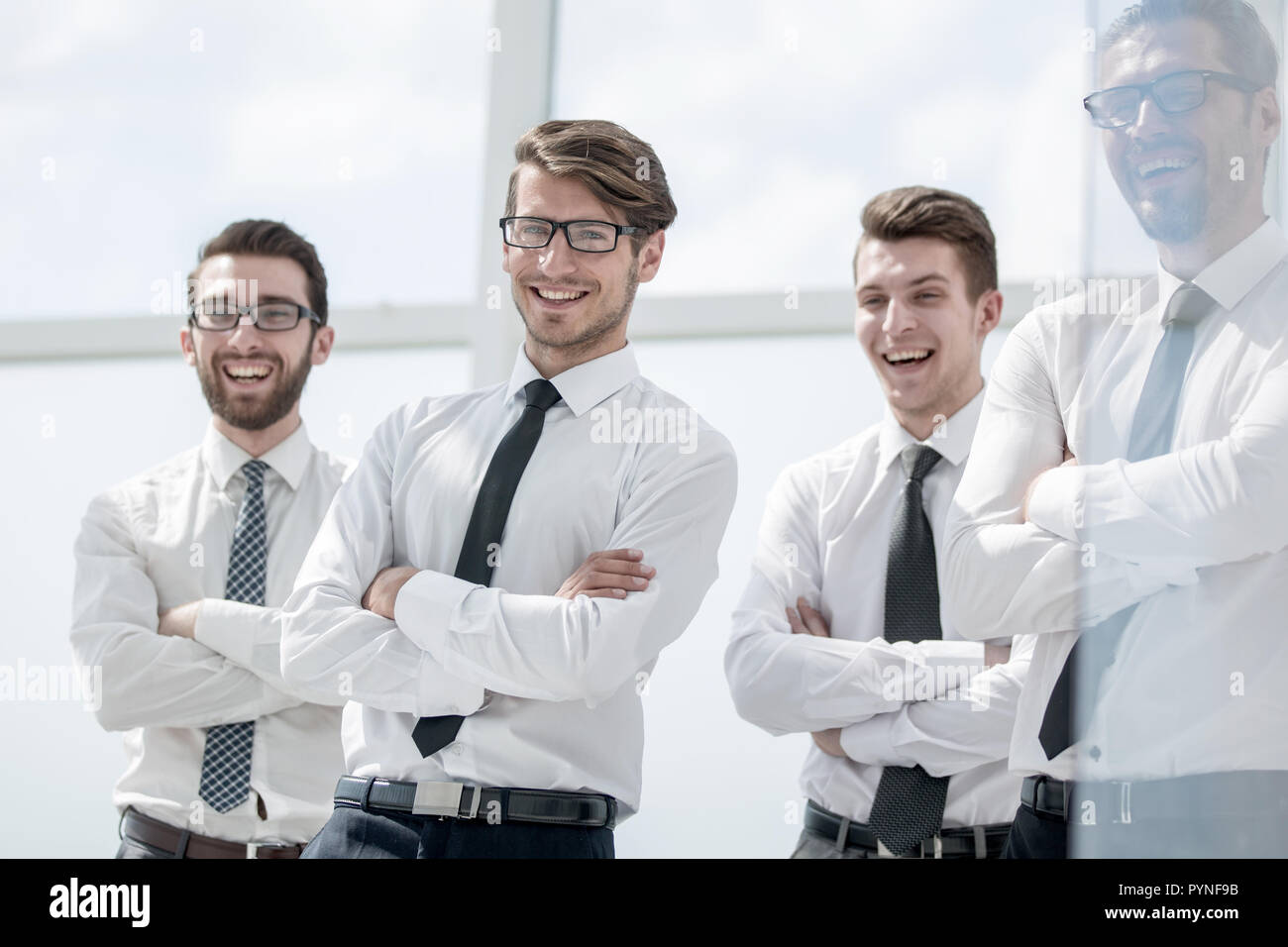 successful employees standing near the office window Stock Photo - Alamy