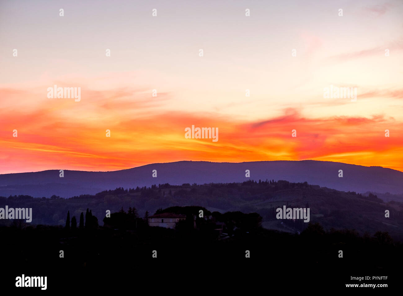 Amazing coloured sunset in Tuscany Italy with red clouds and blue ...