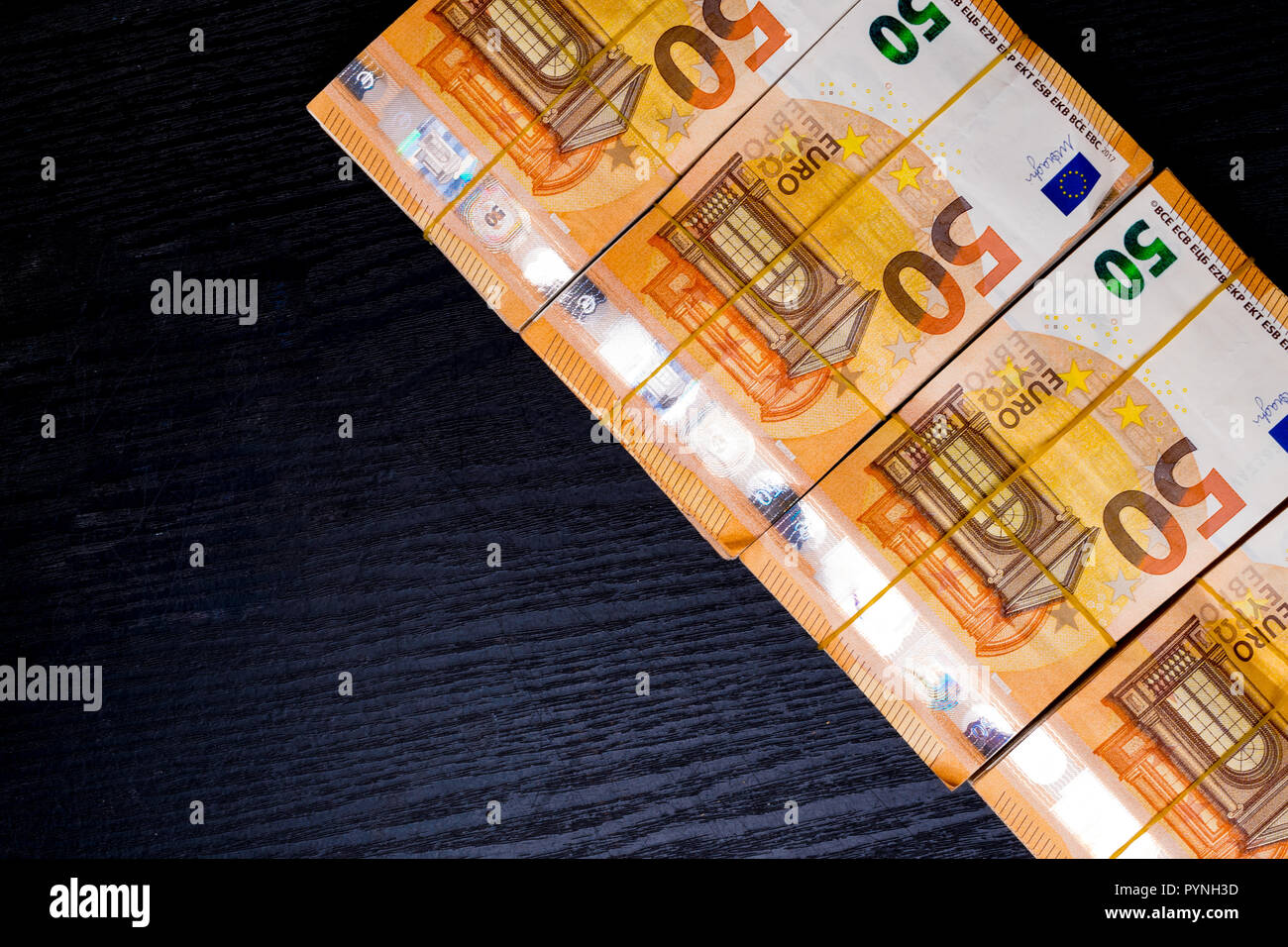 Pile of 50 real euro notes 50-euro banknotes under rubber band ...