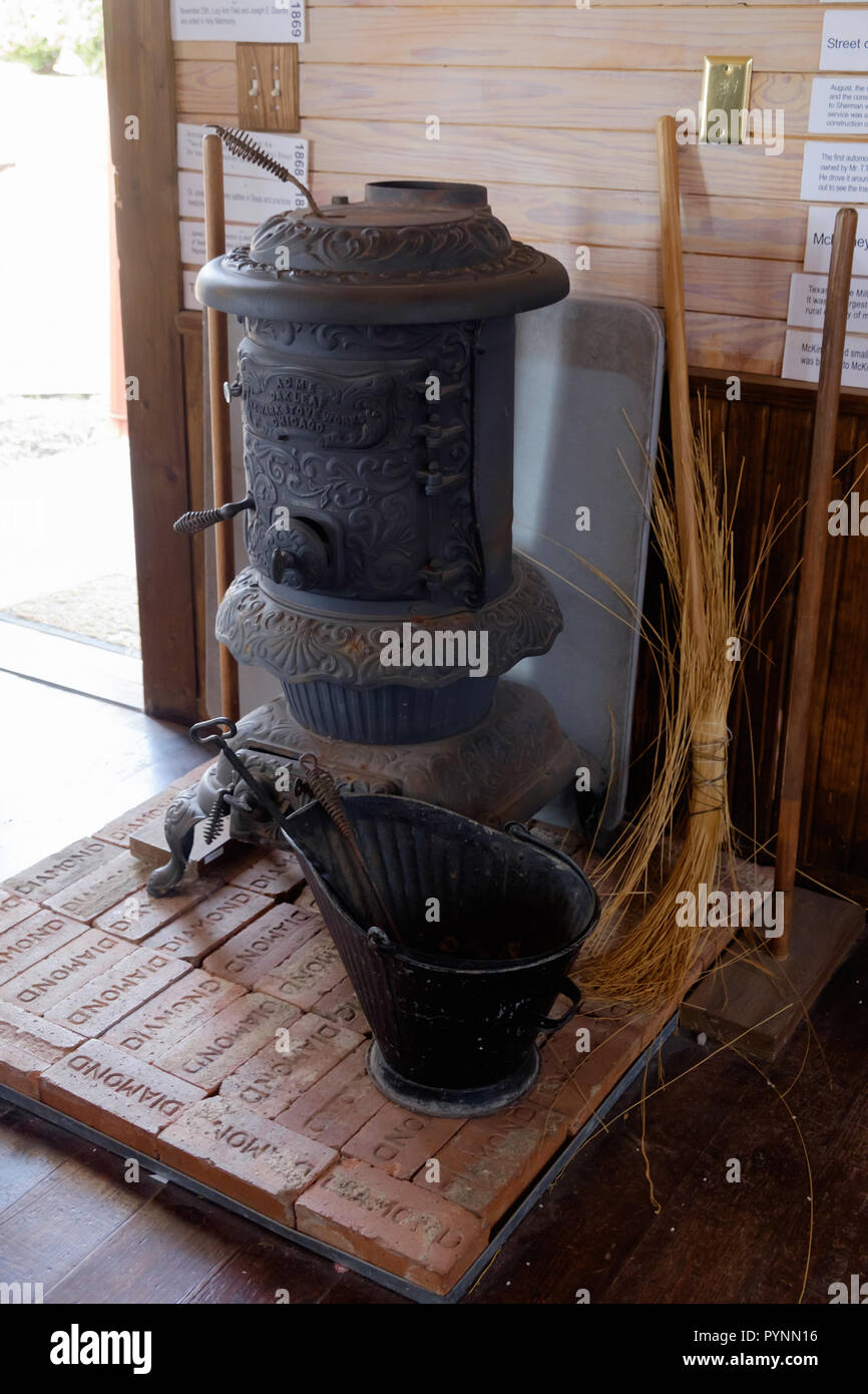Antique Acme Oakleaf Newark Stove on brick platform with straw broom ...