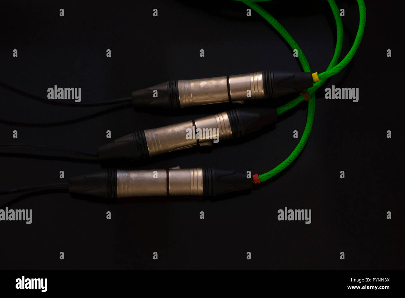 Green of XLR microphone cable on black background Stock Photo - Alamy