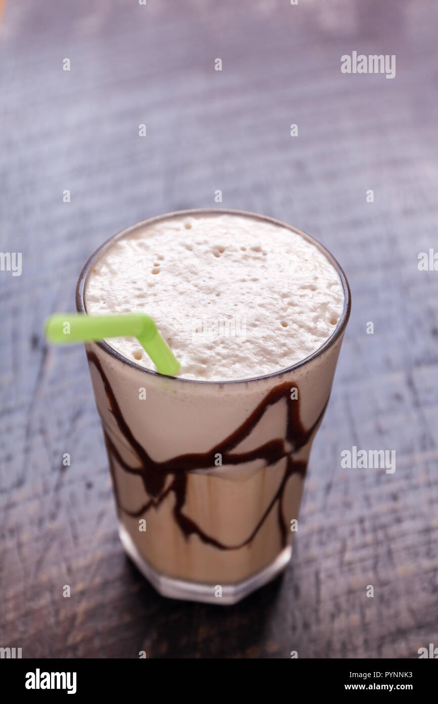 White Frappe Coffee Glass with iced drink with chocolate syrup on a ...