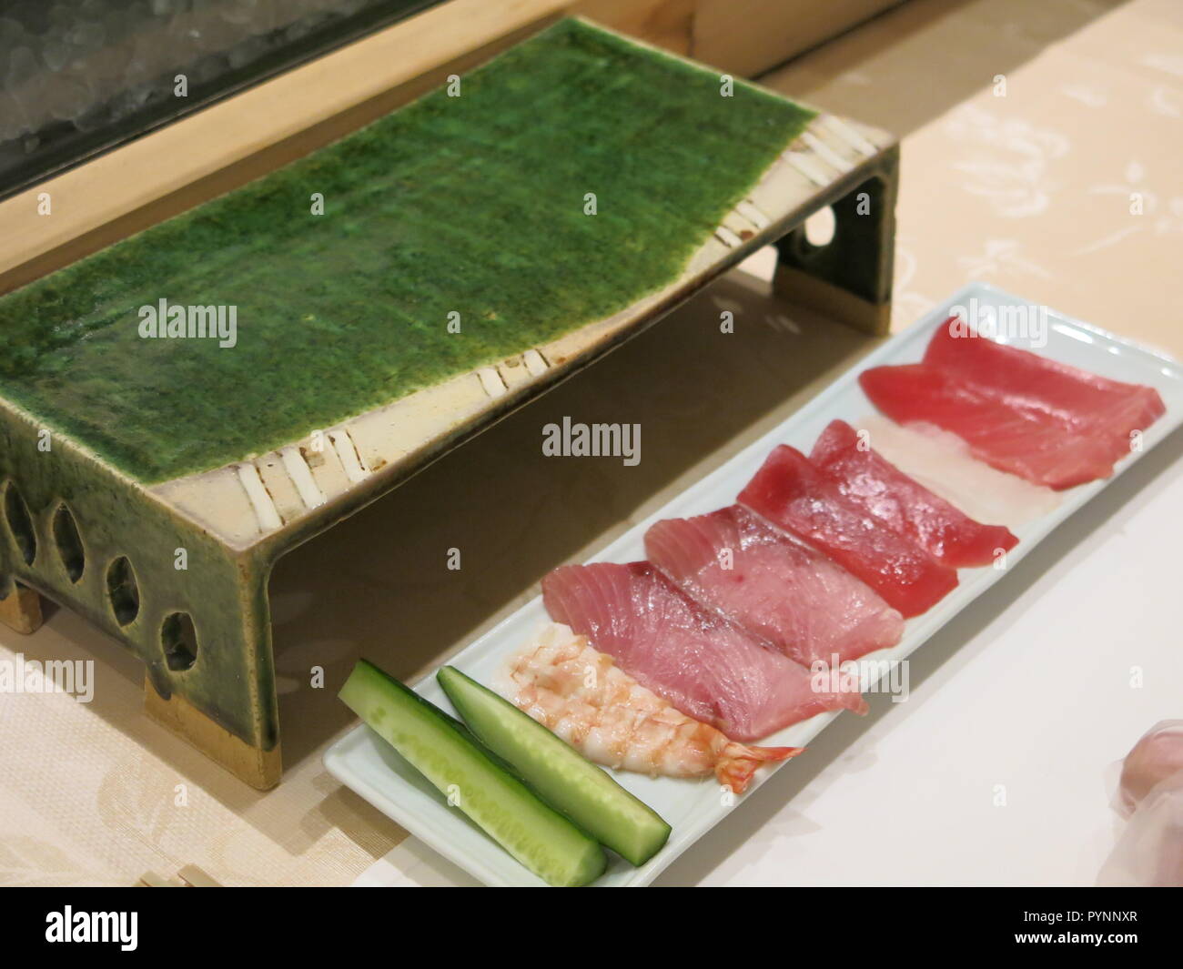 A dish of sliced fish is ready for the sushi preparation in a Japanese ...
