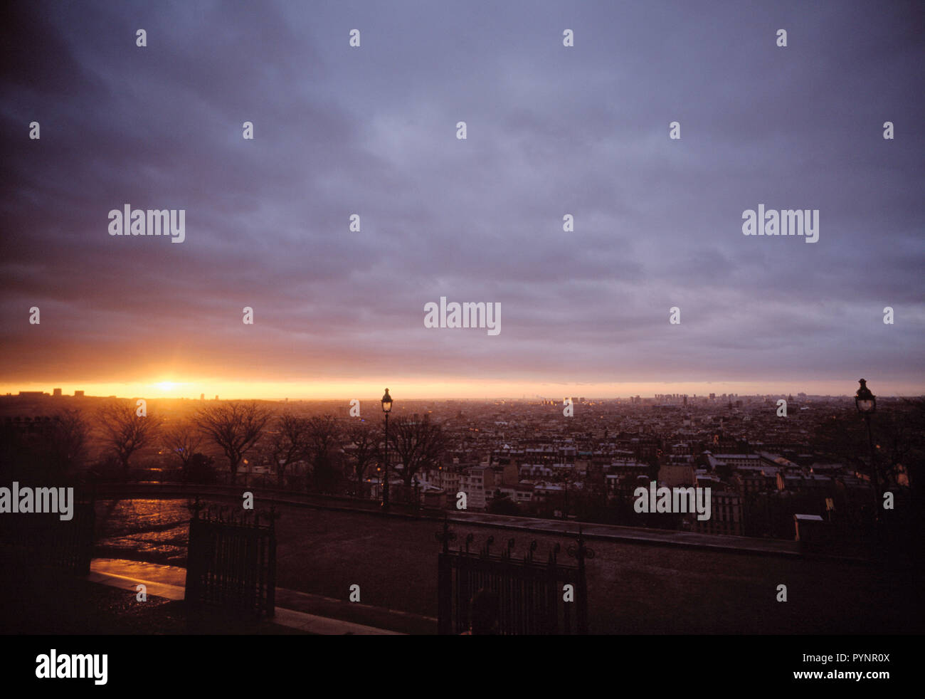 Romantic sunset over a city on an overcast evening Stock Photo - Alamy