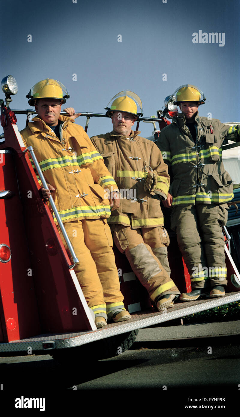 Three firemen pose for the camera Stock Photo - Alamy