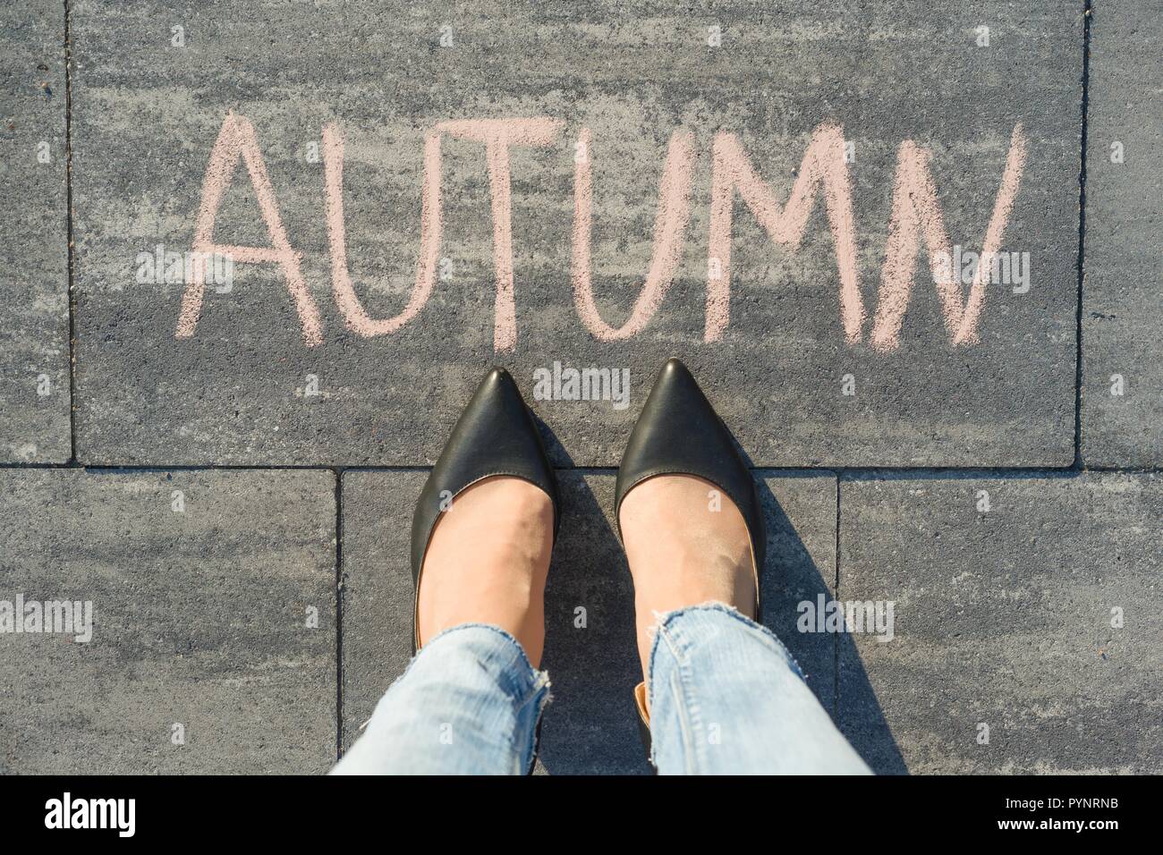Female feet with text autumn written on grey sidewalk Stock Photo - Alamy