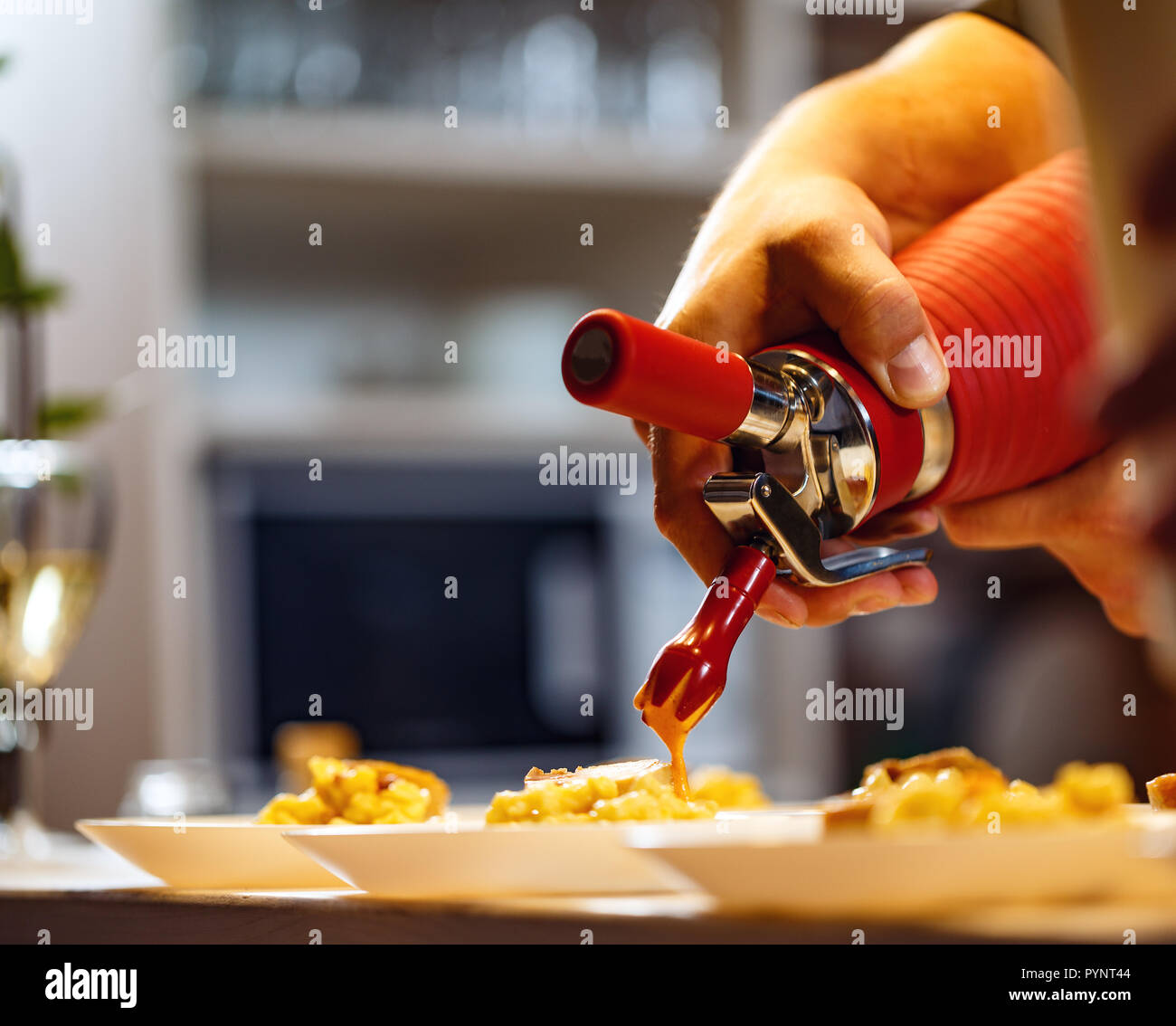Creative kitchen concept, chef decorating his plate Stock Photo - Alamy