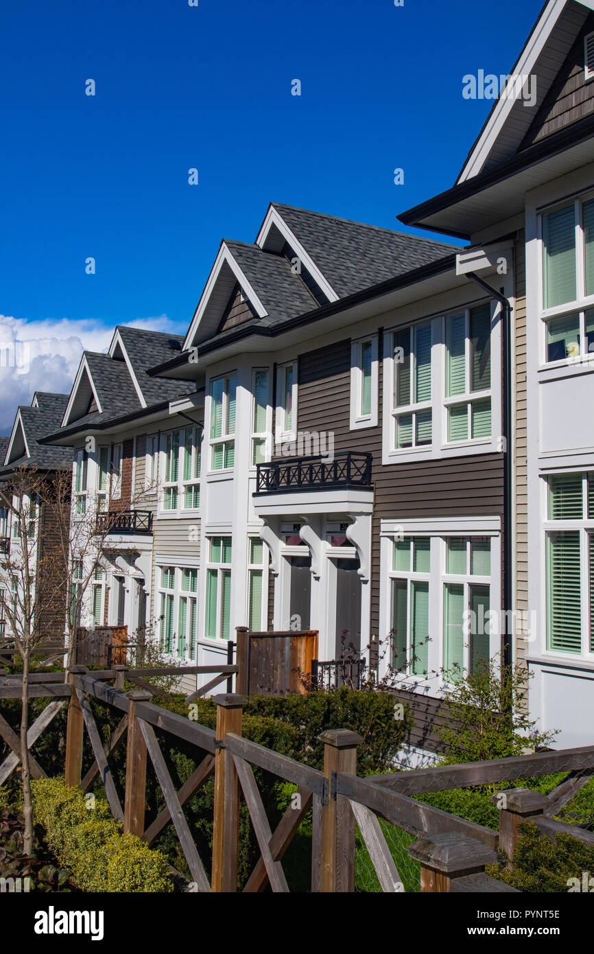 Suburban residential street townhomes. On bright sunny spring day ...