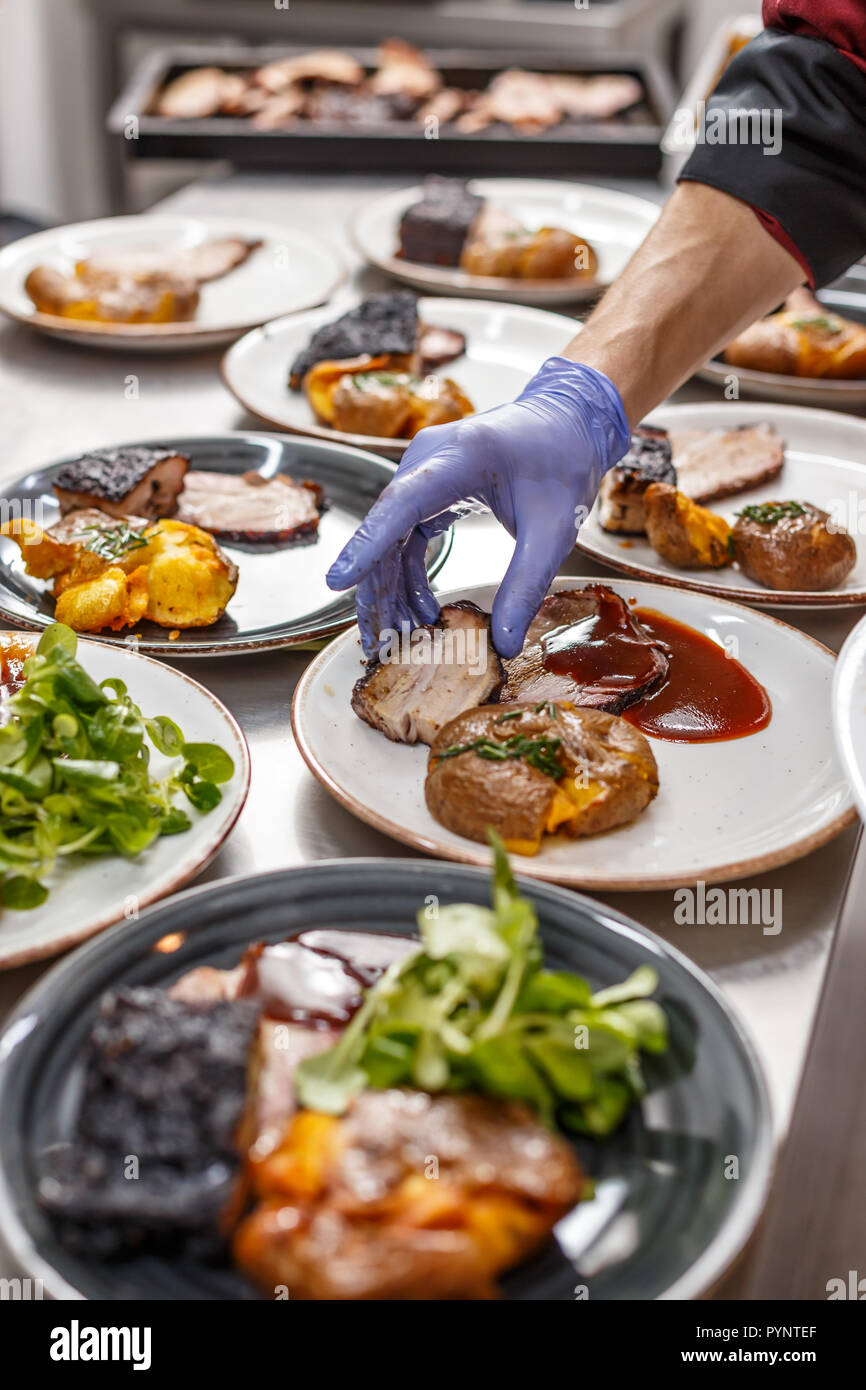 Chef is making a barbecue dish on restaurant kitchen Stock Photo - Alamy