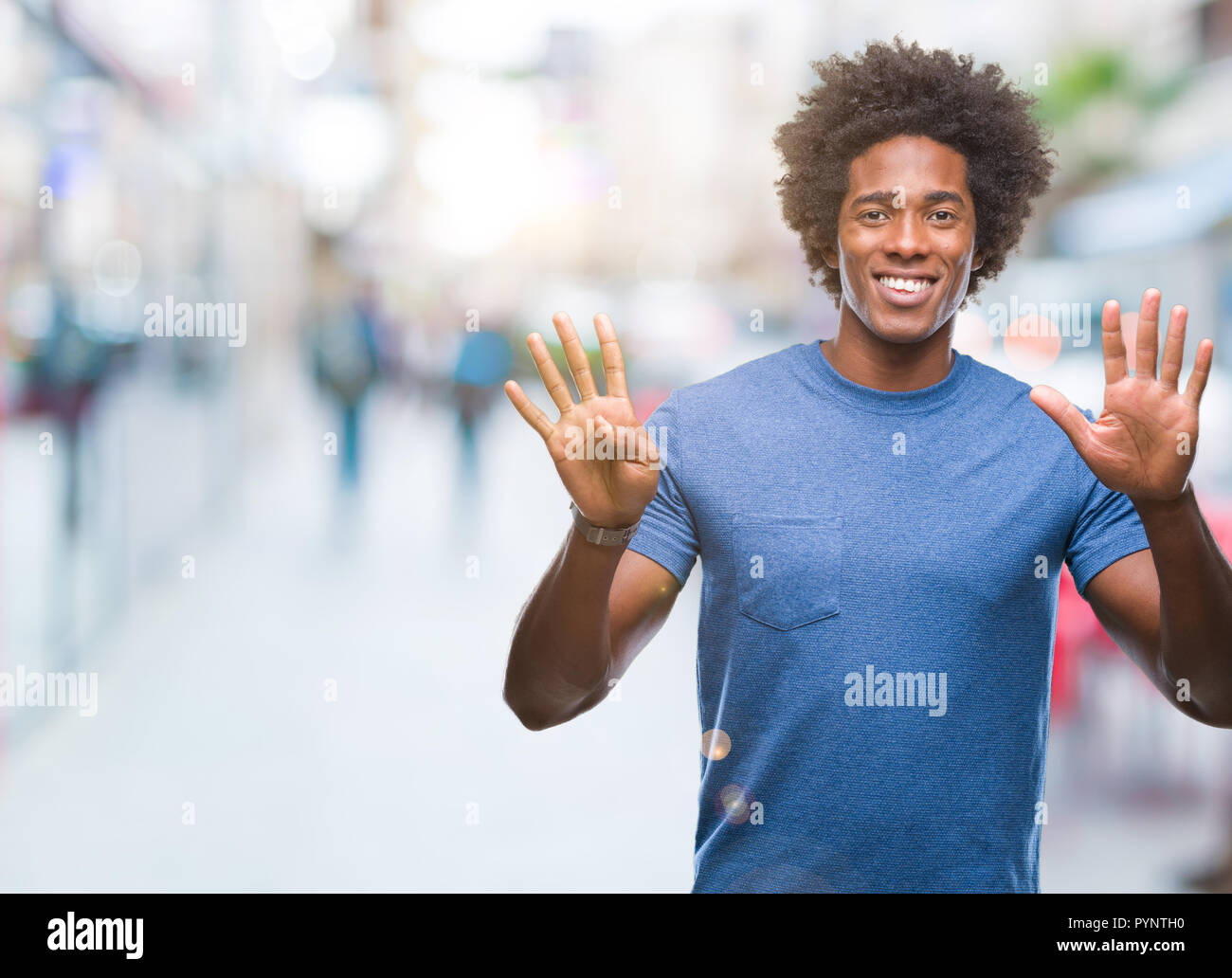 Afro american man over isolated background showing and pointing up with ...