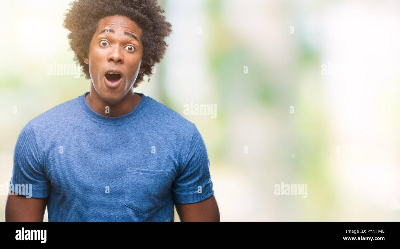 Afro american man over isolated background afraid and shocked with ...