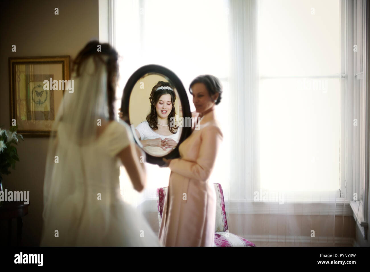 Young bride getting ready with her mother Stock Photo - Alamy