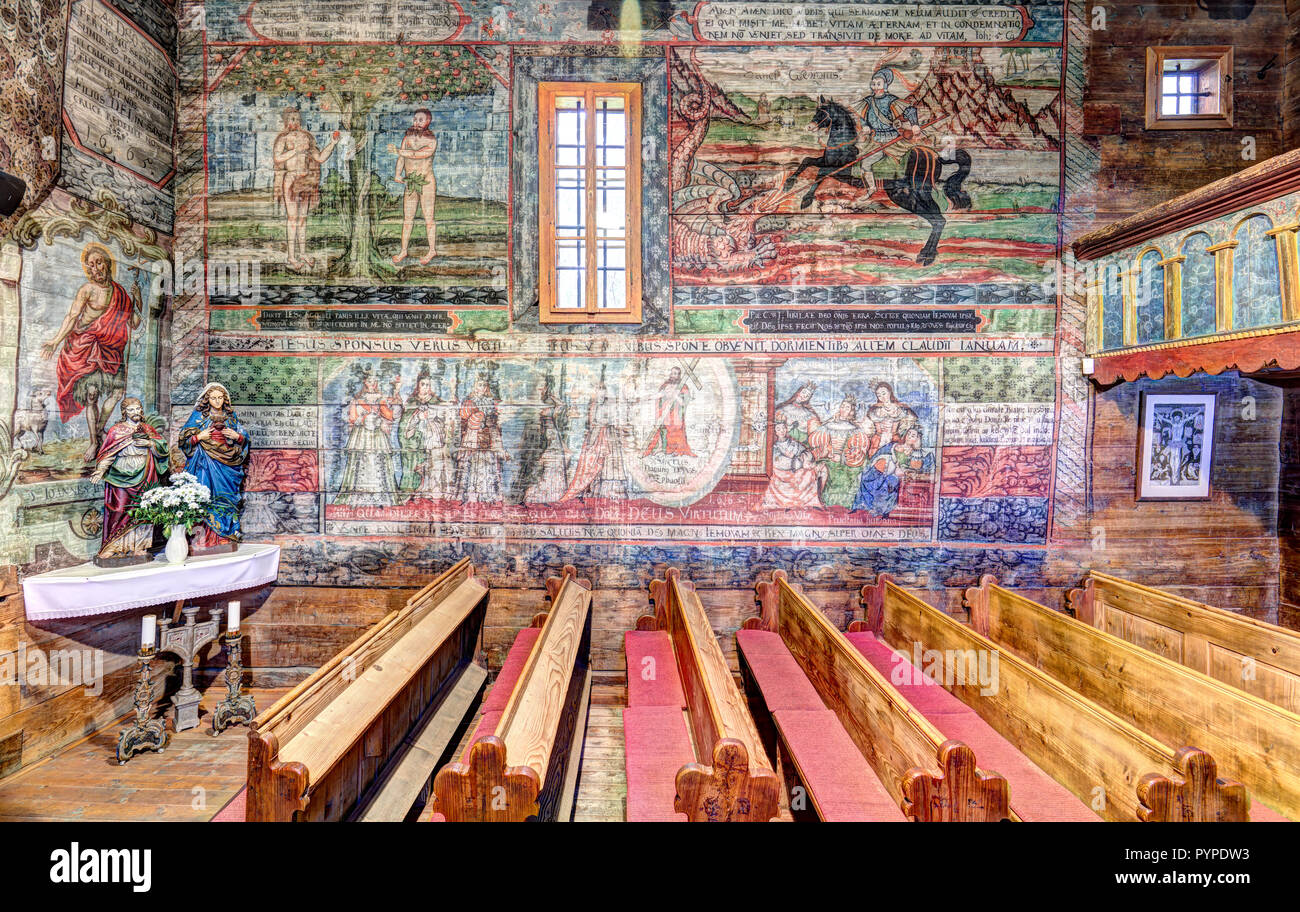 Painted wall the small wooden church in Hervartov, Slovakia Stock Photo ...