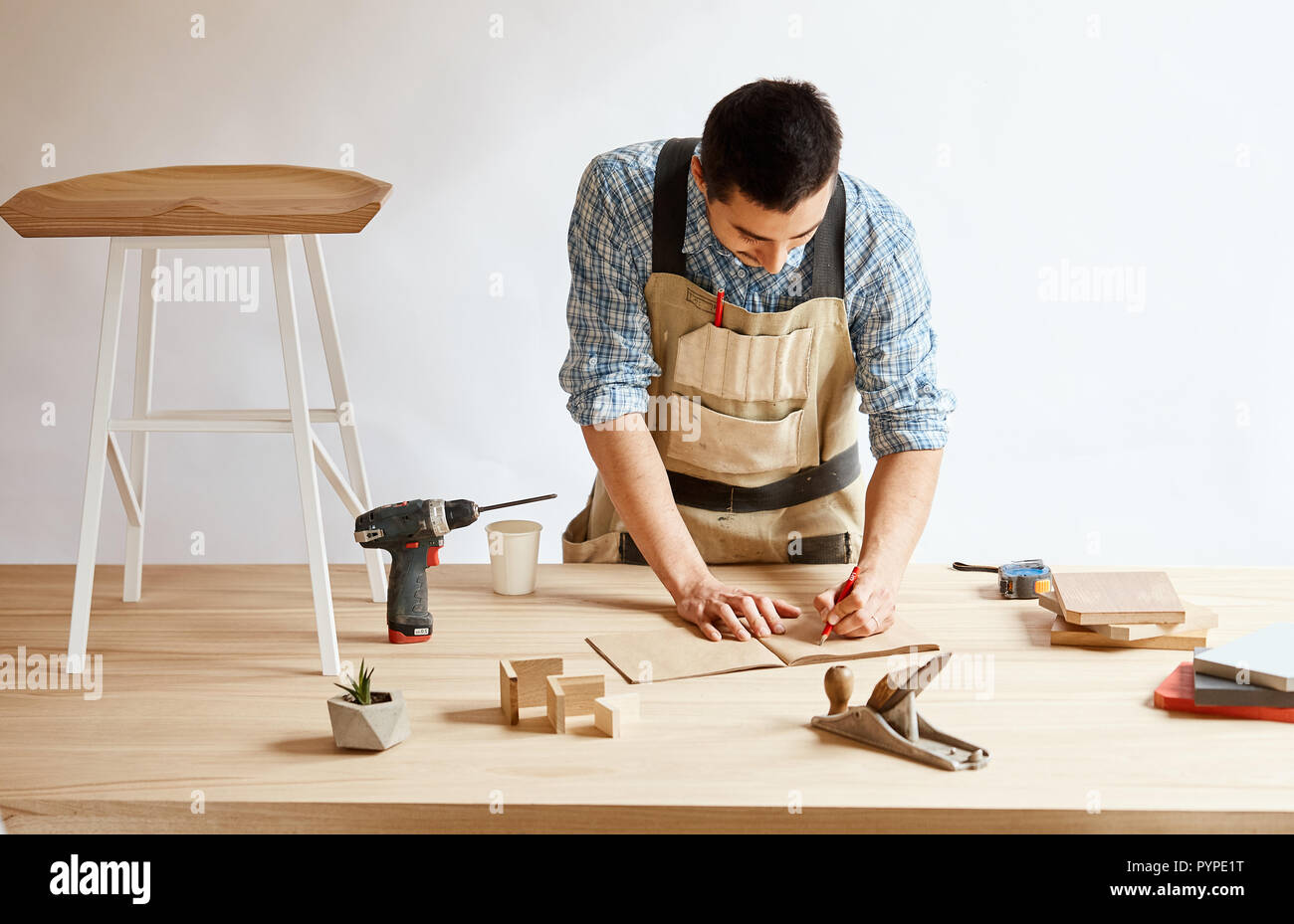 Carpenter man making draft plan using pencil on the table with tools ...