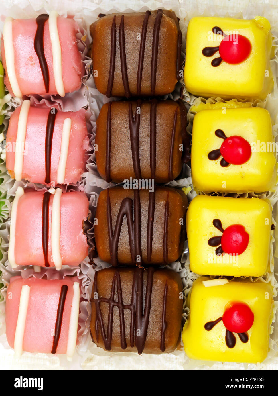 Colourful sugary mignon cakes close up Stock Photo - Alamy