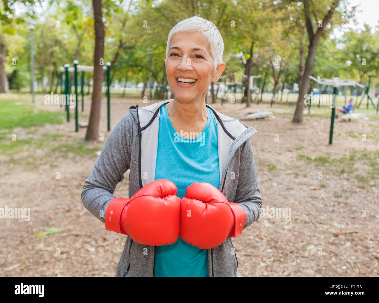 Portrait Of Fit Senior Woman With Boxing Glove At Outdoor Fitness Park ...