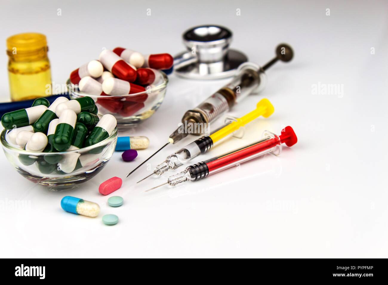 Assorted medical drugs and syringe on white background. Injection for ...